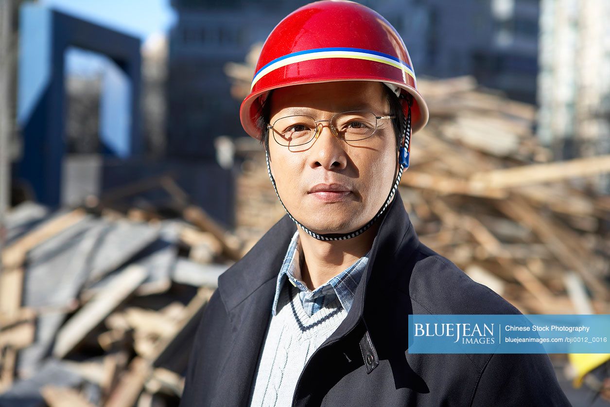 Chinese businessman in construction site wearing hard hat-High-res ...