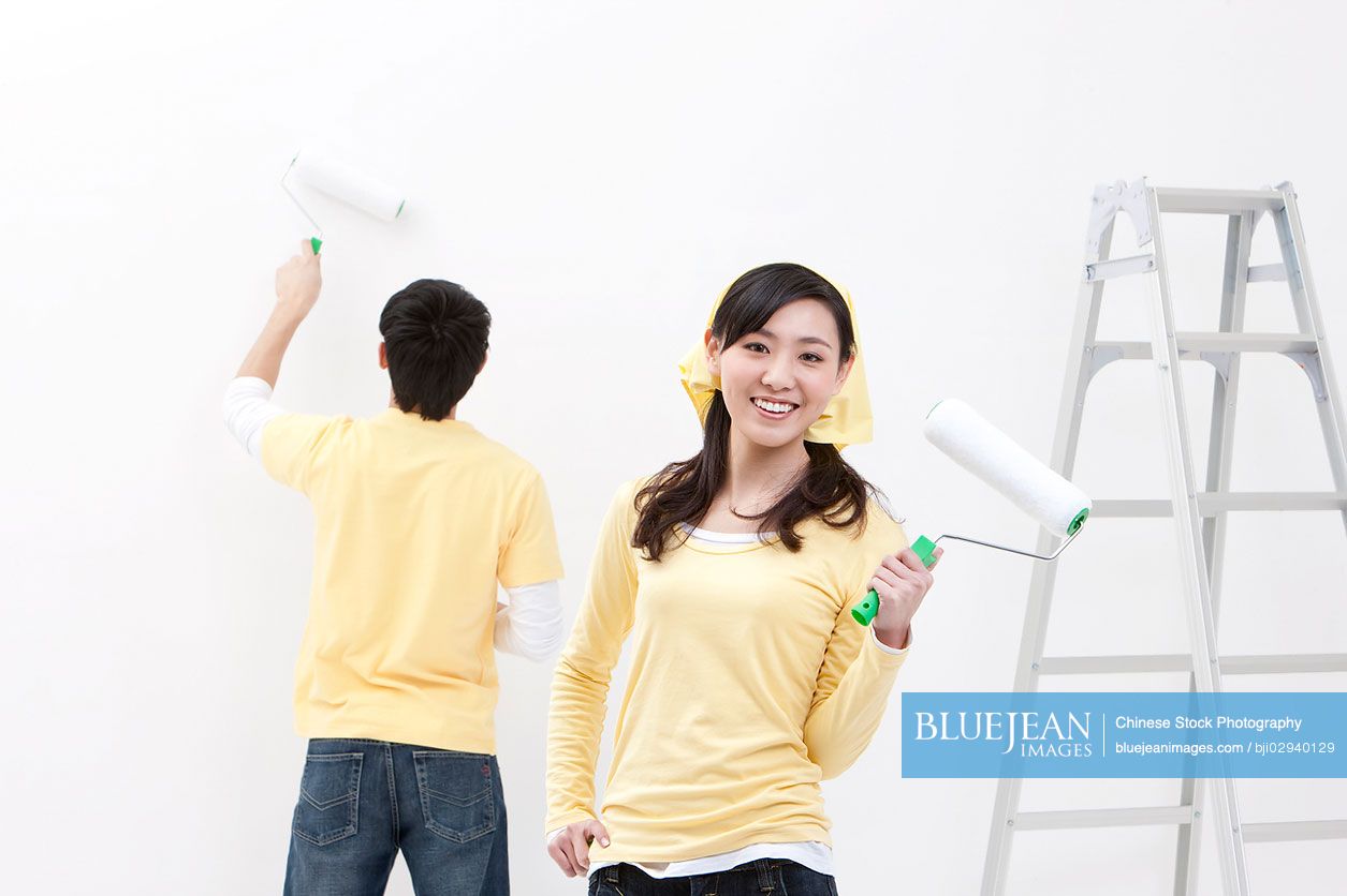Happy young Chinese couple doing DIY home improvement-High-res stock ...