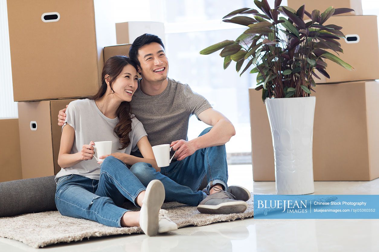 Happy young Chinese couple moving to a new house-High-res stock photo ...
